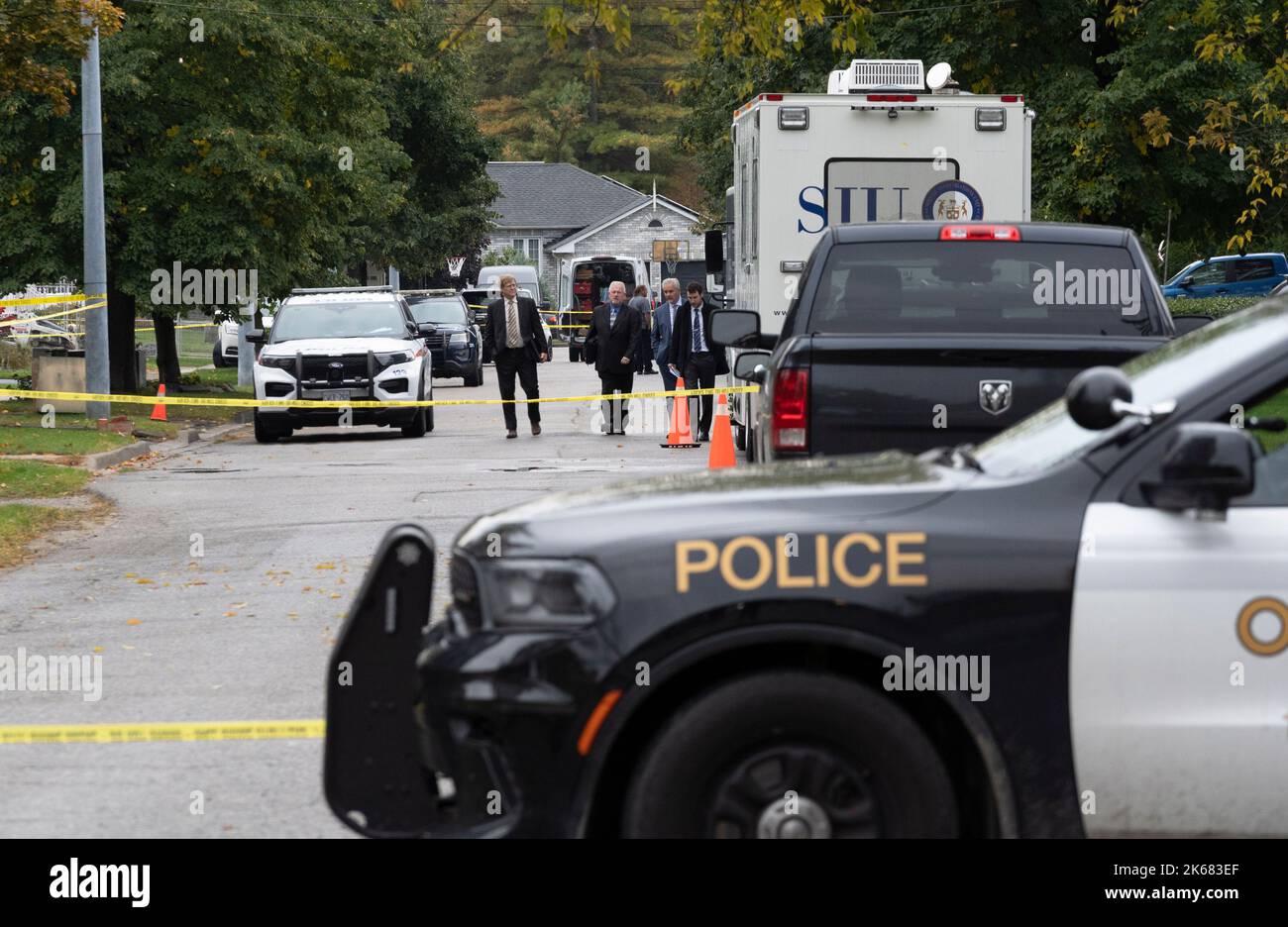 Police and SIU investigators gather at the scene where two police ...
