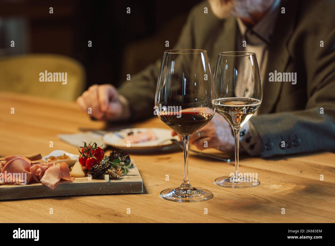 People drinking wine and eating cold cut meat in a wine cellar Stock ...