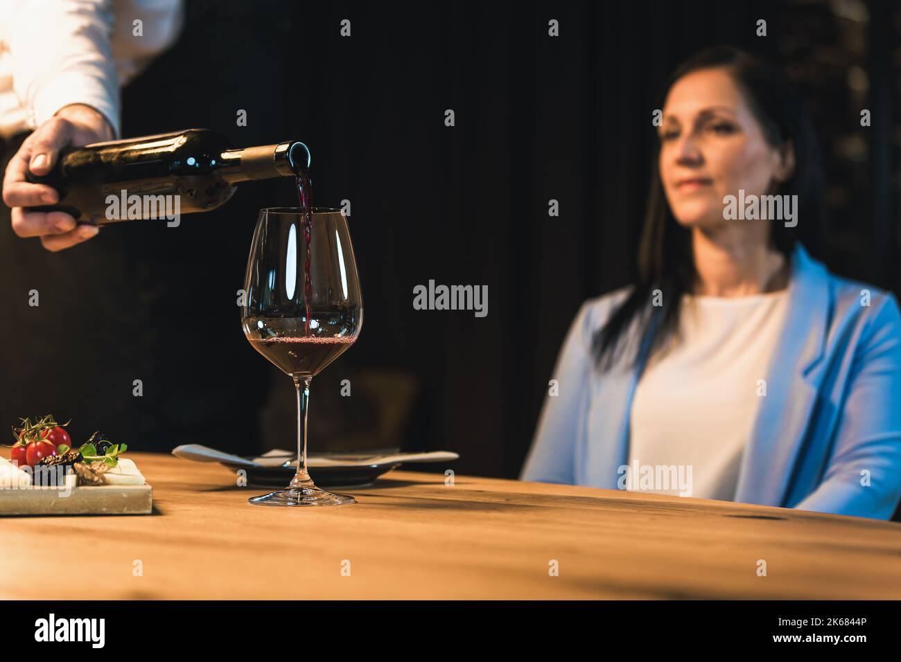 People drinking wine and eating cold cut meat in a wine cellar Stock ...