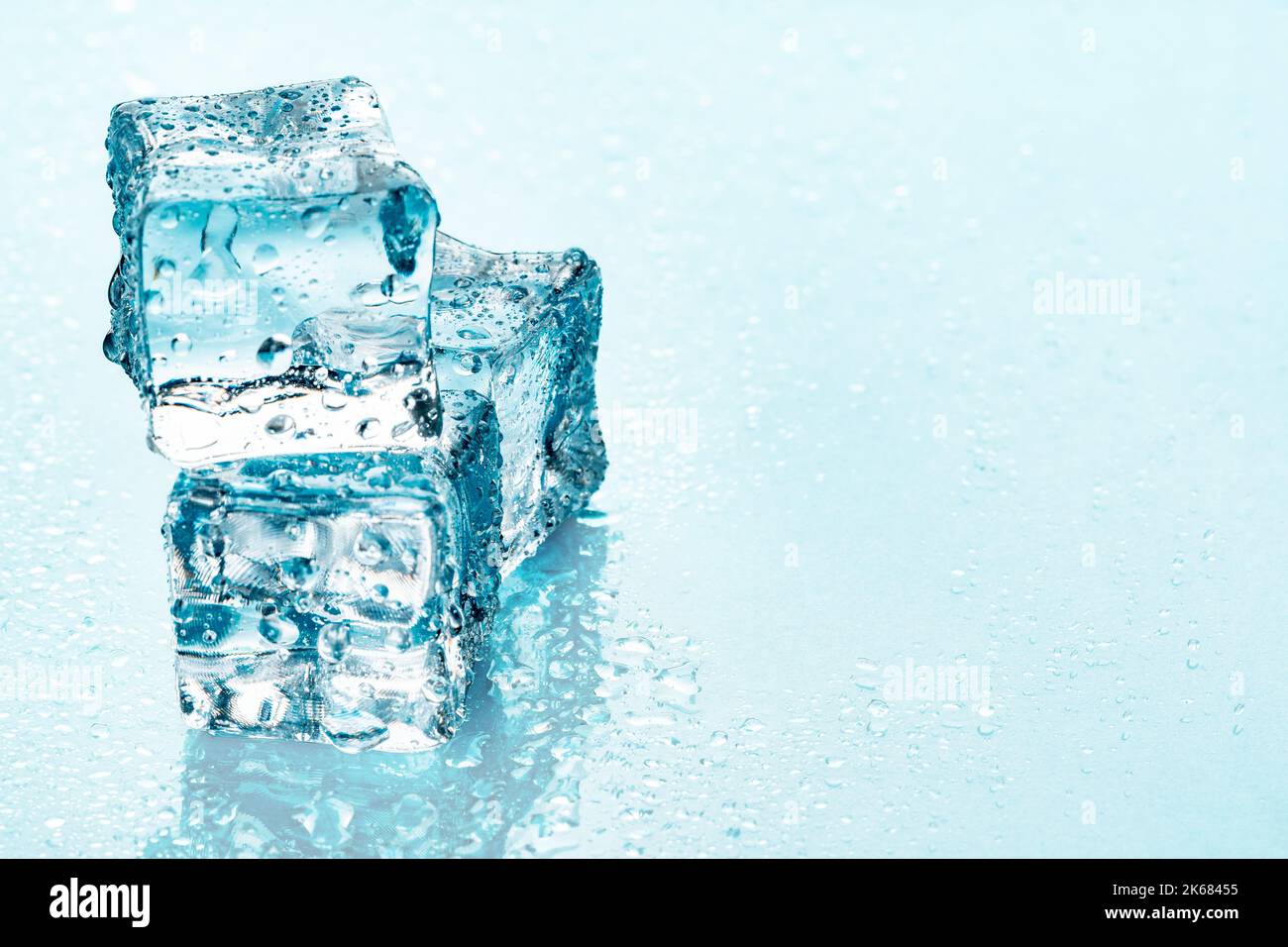 ice cubes on blue background Stock Photo - Alamy
