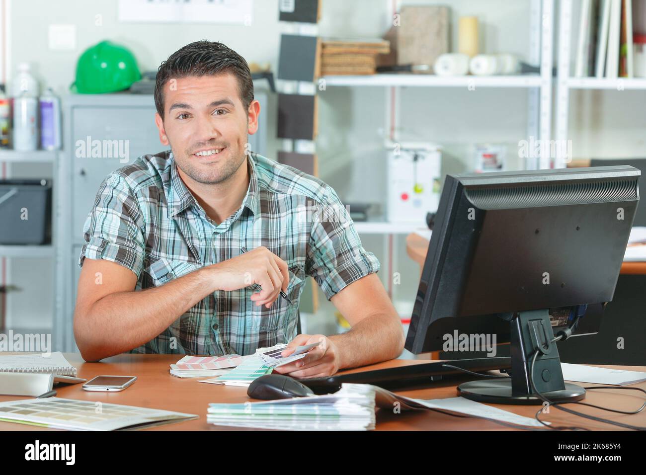 Designer sat at his desk Stock Photo - Alamy