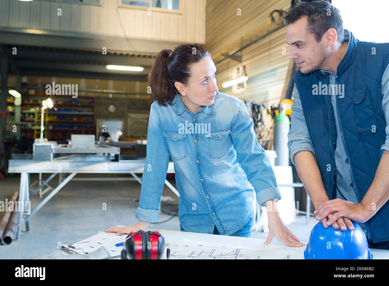 two factory workers with documents in hand Stock Photo - Alamy