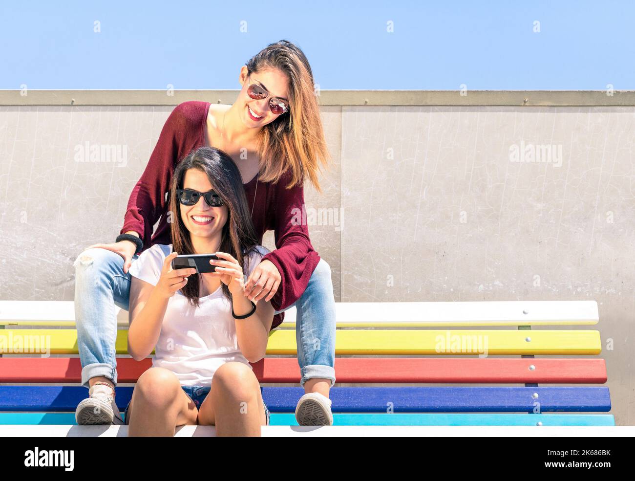 Best friends enjoying time together outdoors with smartphone - Concept ...