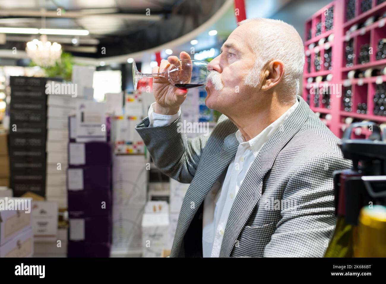 man in suit sampling wine Stock Photo - Alamy