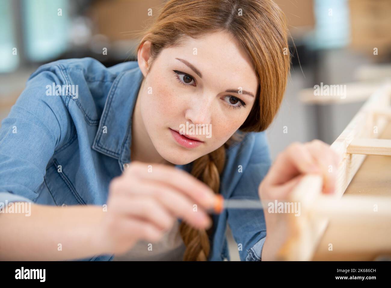 Woman assembling white furniture hi-res stock photography and images ...
