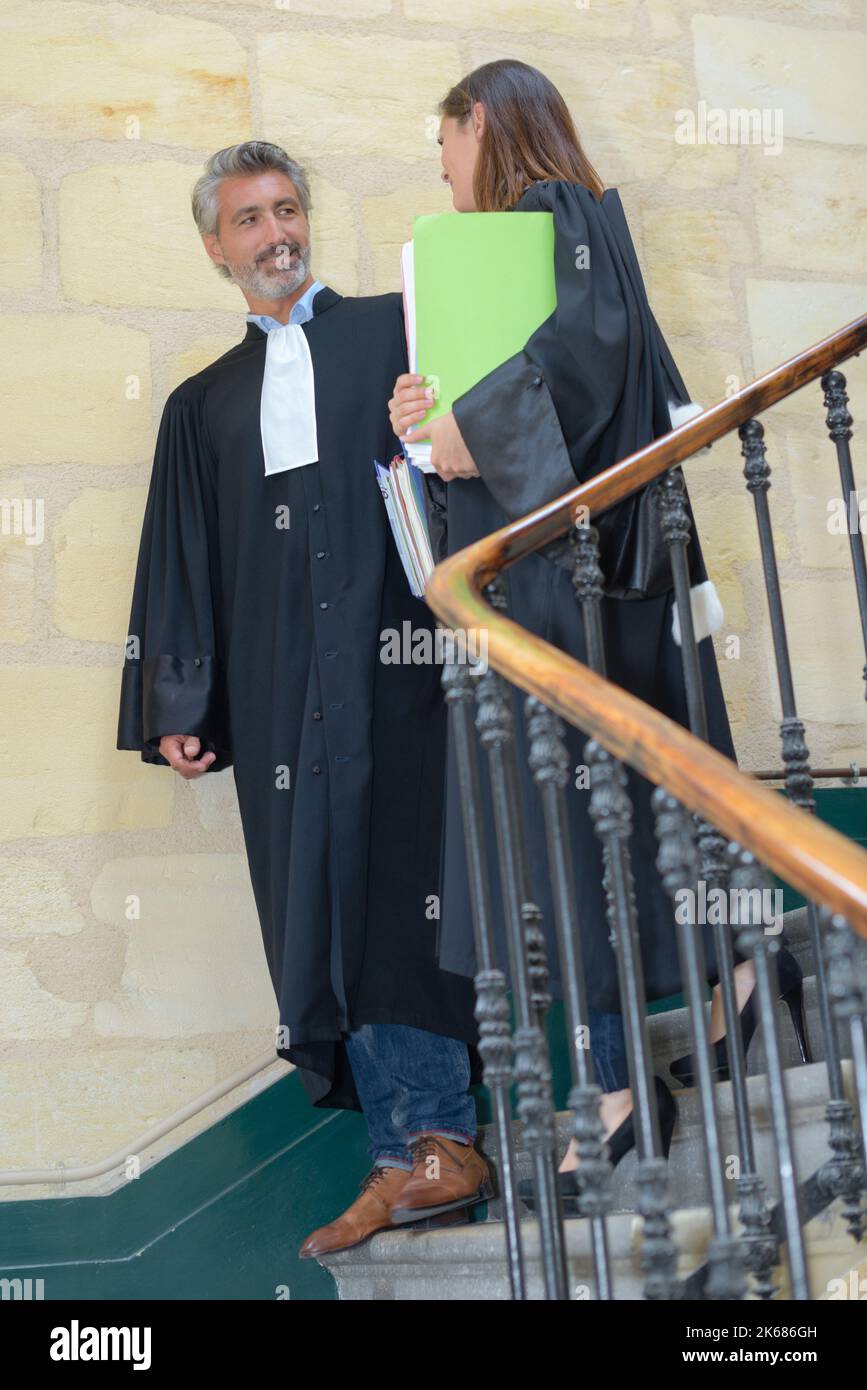 portrait of magistrates walking down staircase Stock Photo - Alamy