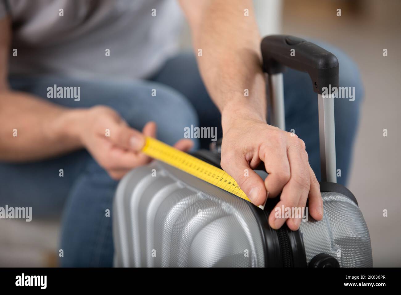 close-up of hands measuring luggage Stock Photo - Alamy