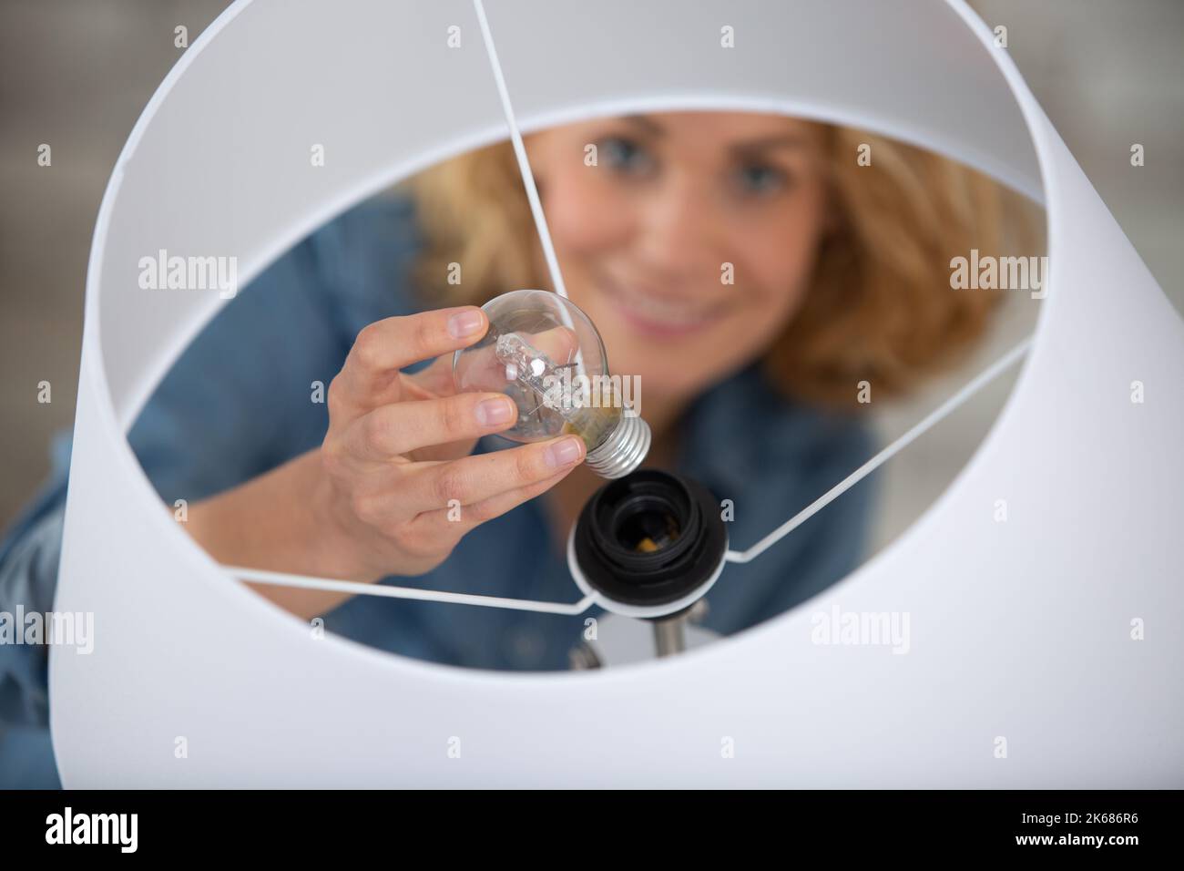 woman changing a light bulb in her home Stock Photo - Alamy