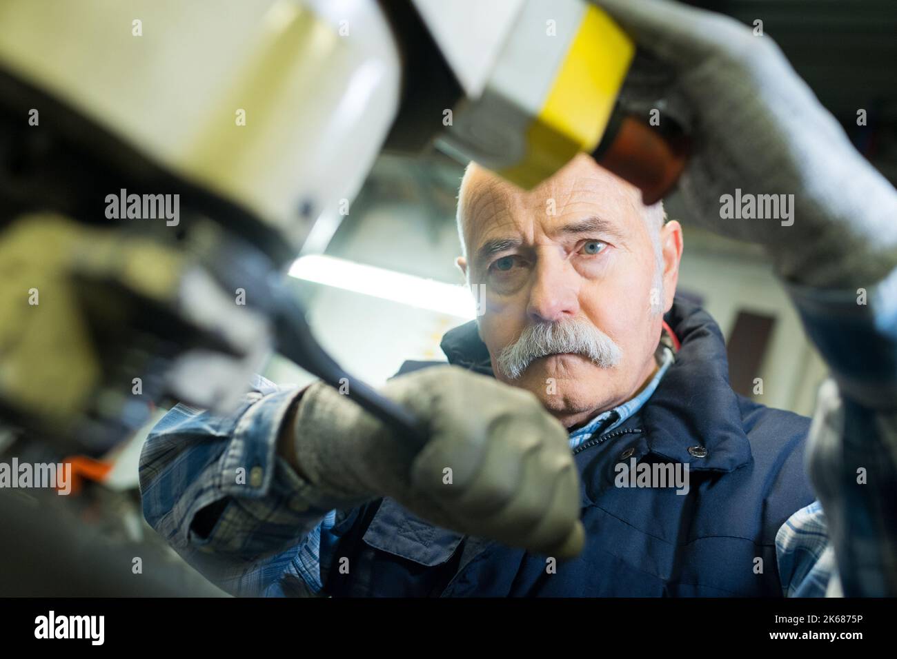 senior mechanic working on car with open bonnet Stock Photo - Alamy