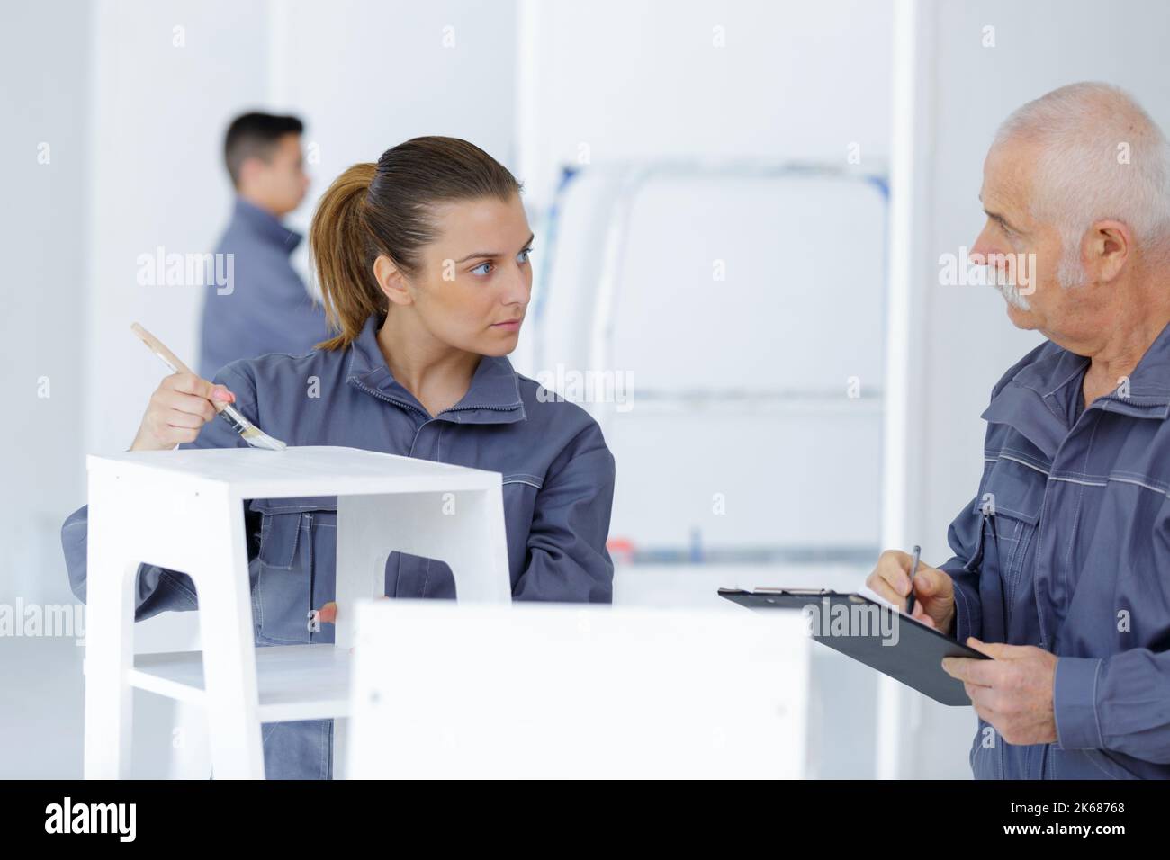 portrait of woman painting renewing chair Stock Photo - Alamy
