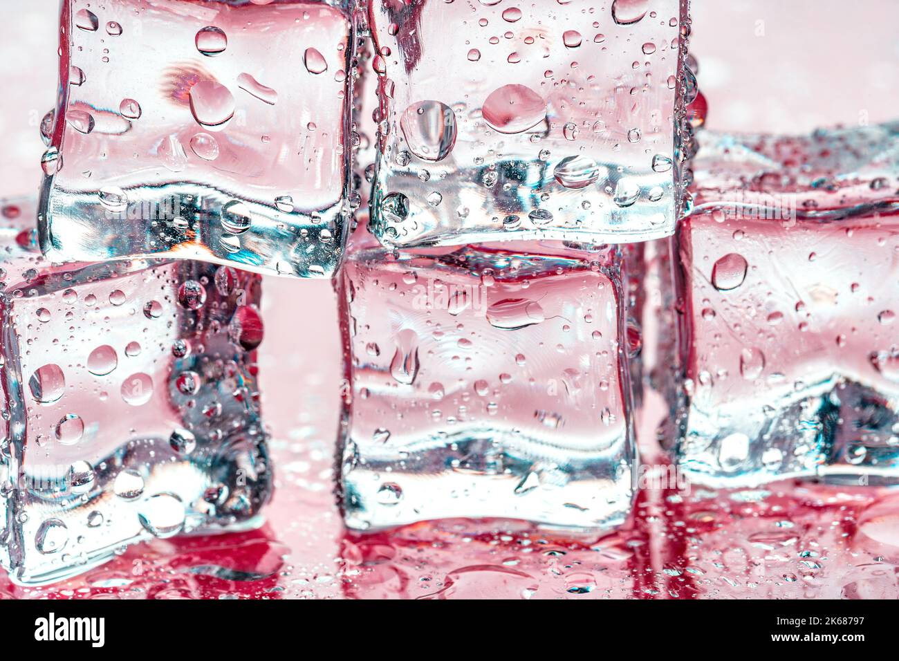 Ice cubes on pink background Stock Photo - Alamy