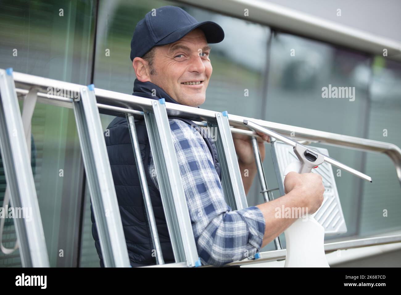 a construction worker carrying ladder Stock Photo - Alamy