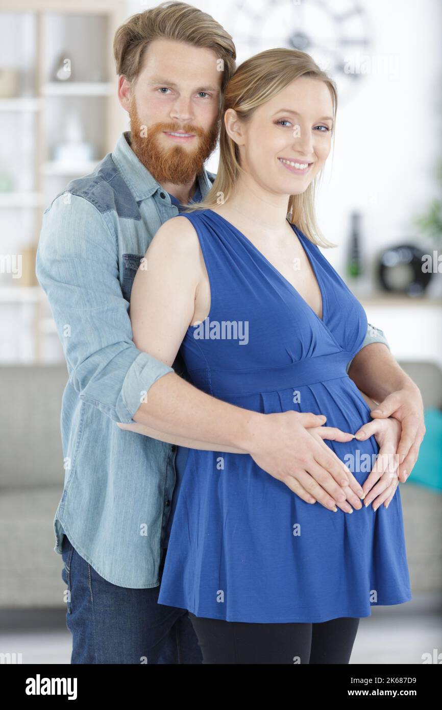 a happy pregnant couple hugging Stock Photo - Alamy