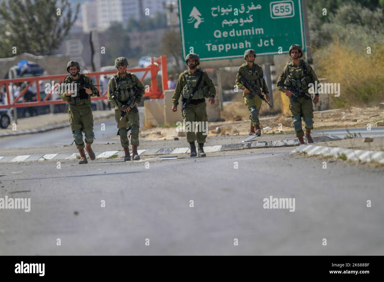 Israeli soldiers patrol the road as the Jewish settlers close the ...