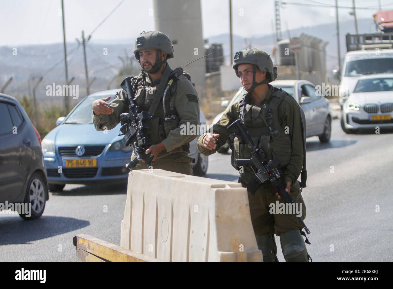 Israeli soldiers stand guard against Palestinians while the Jewish ...