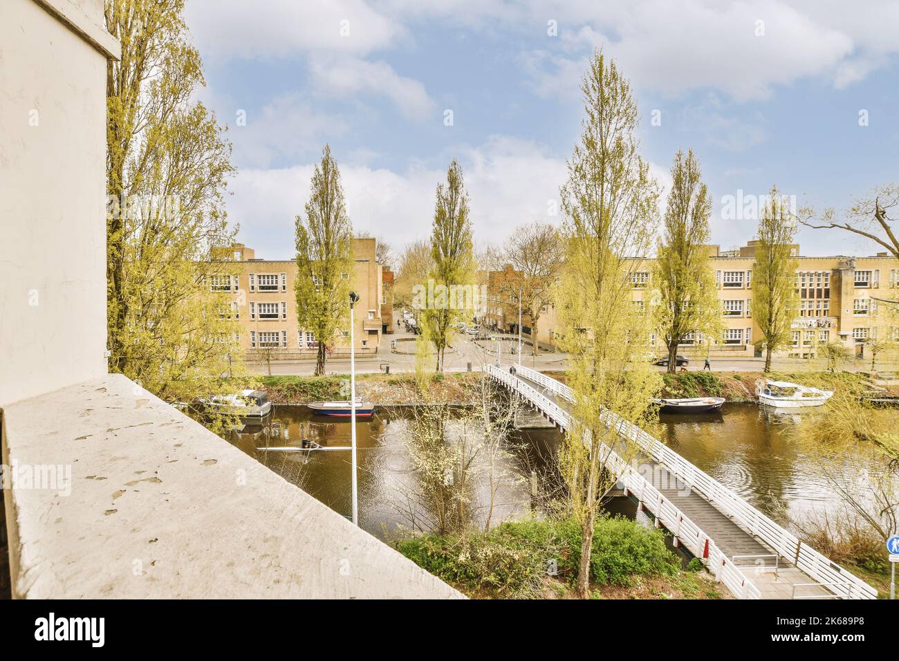 Front view of old brick buildings from small balcony with railings ...