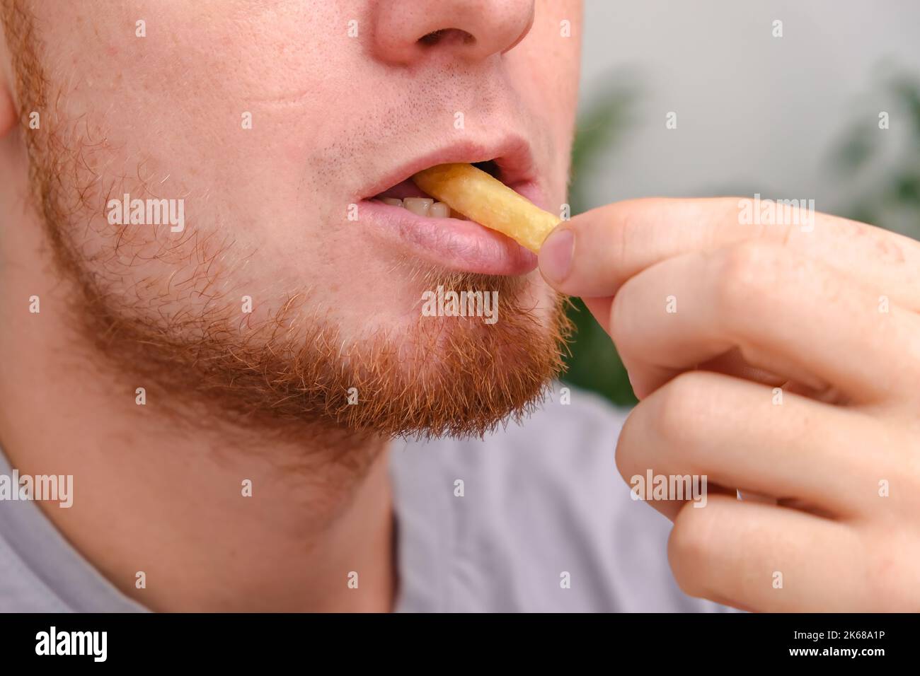 Young man eats junk food hi-res stock photography and images - Alamy