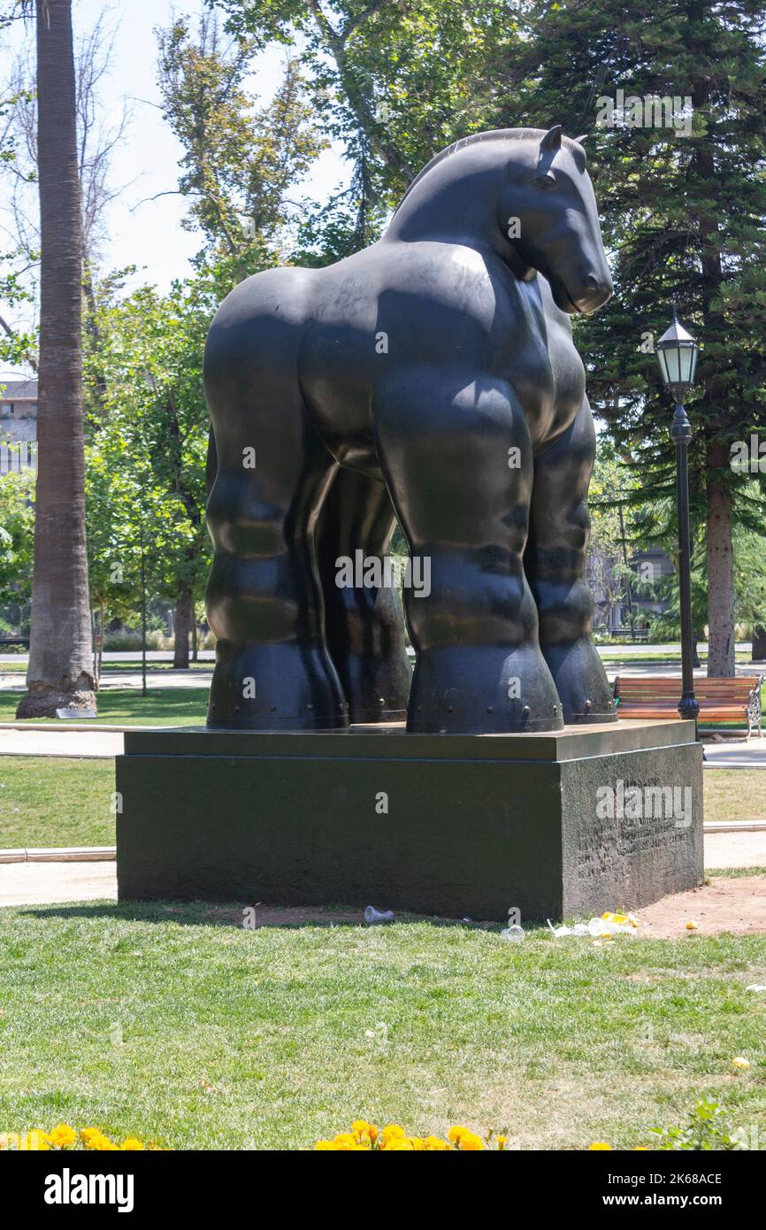 A vertical shot of the sculpture of a fat horse by Fernando Botero in ...