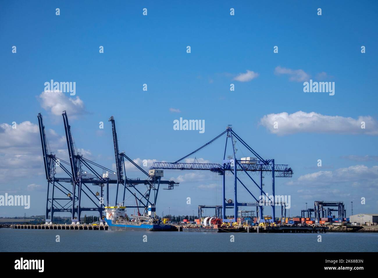 London Thamesport container port with gantry cranes loading a ship ...