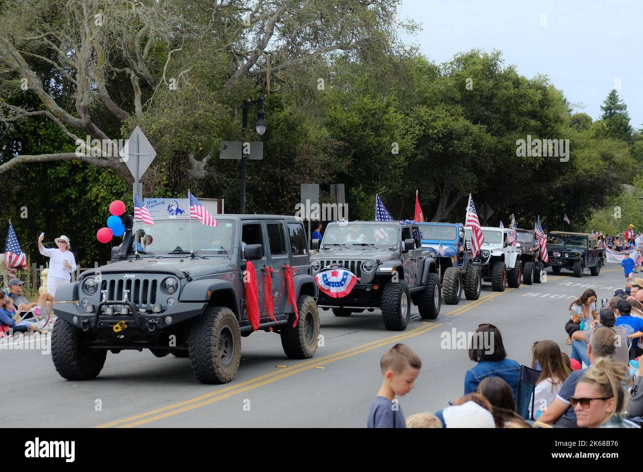 4wd off-road jeep-type vehicles decorated with the American flag in an ...
