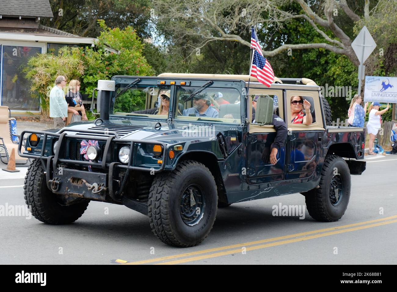 A caucasian family driving a military hummer humvee vehicle decorated ...