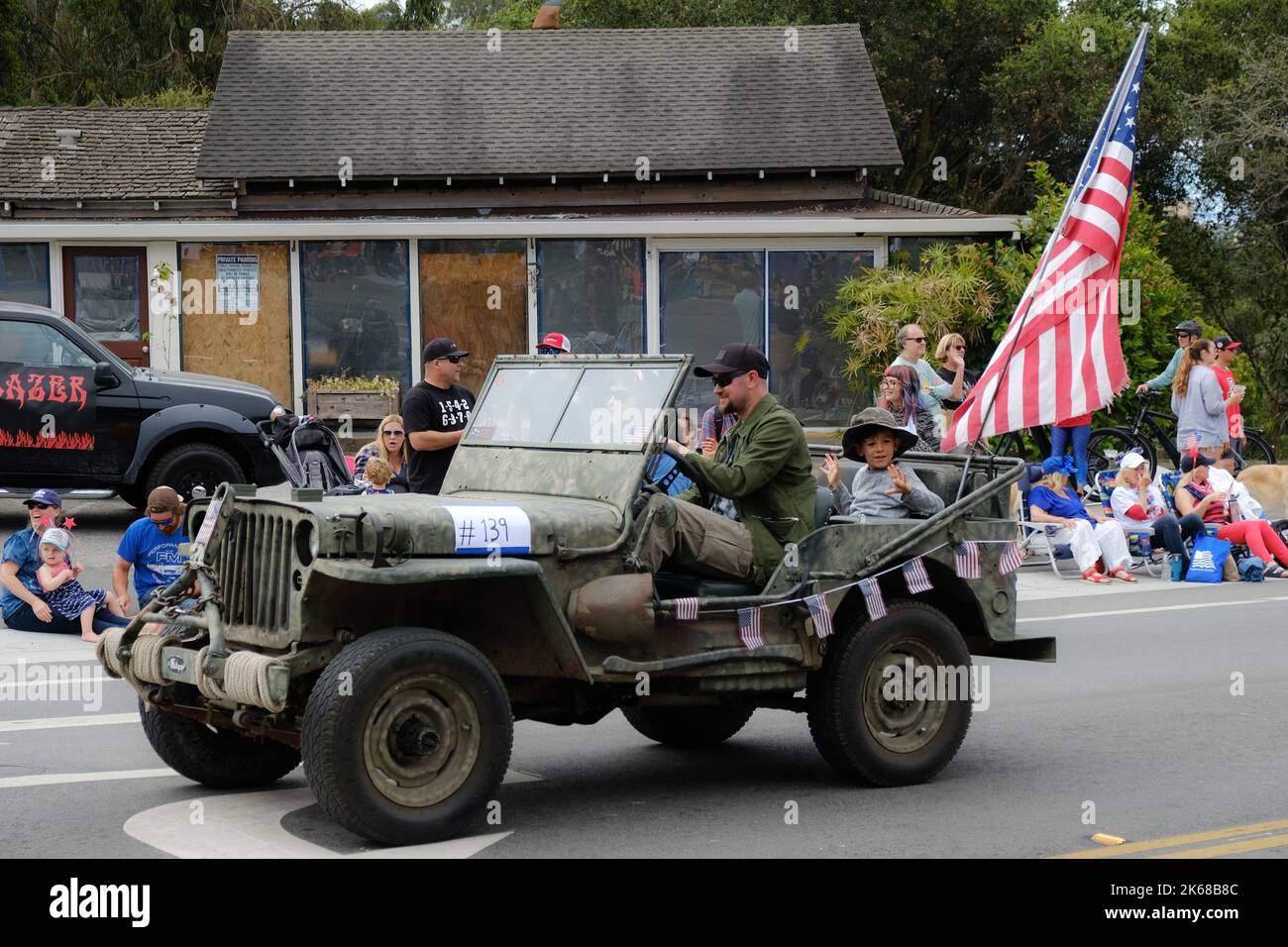 A military jeep with a prominently displayed American flag in an ...