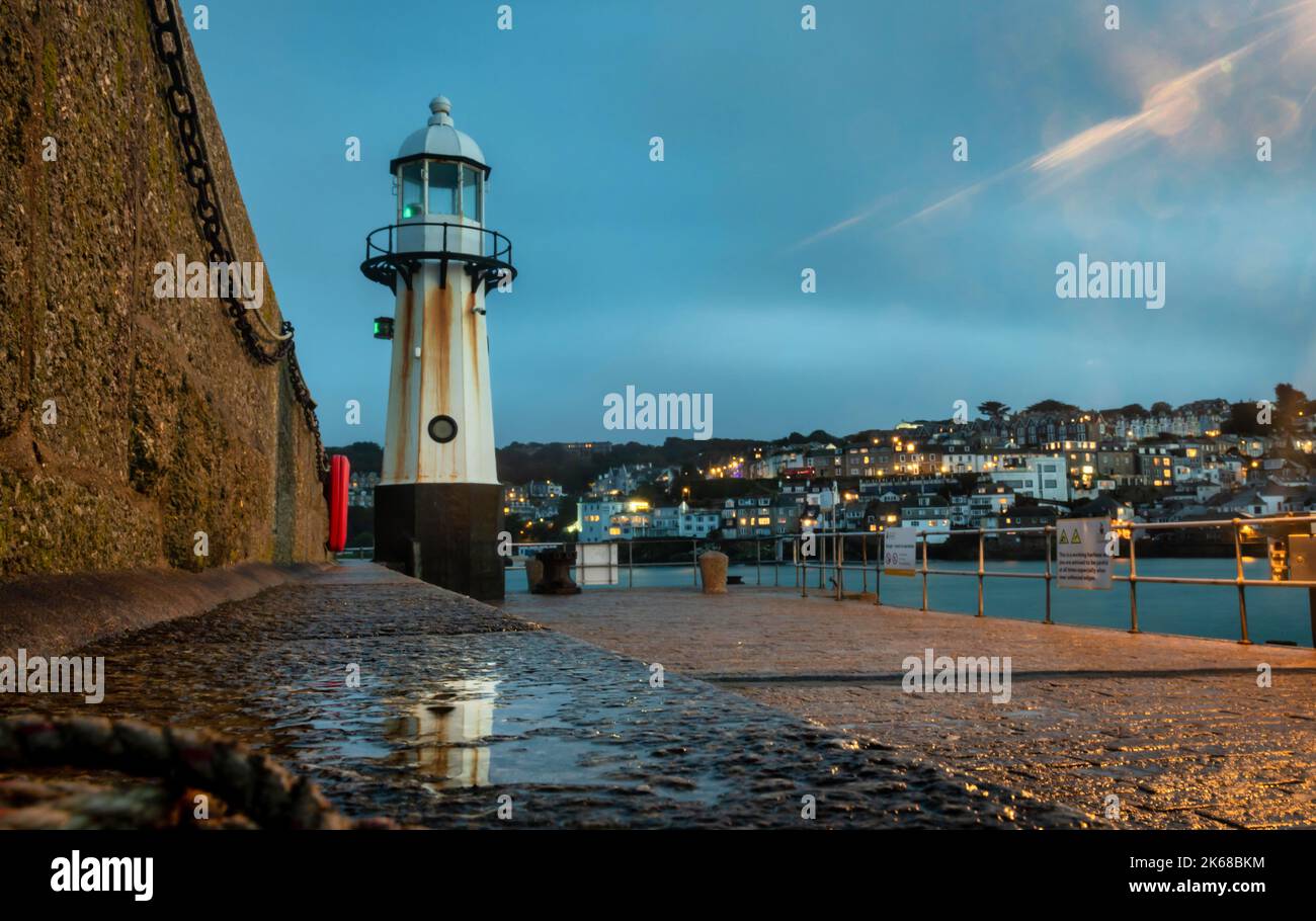 St Ives Lighthouse taken from a low angle and with a puddle reflection ...