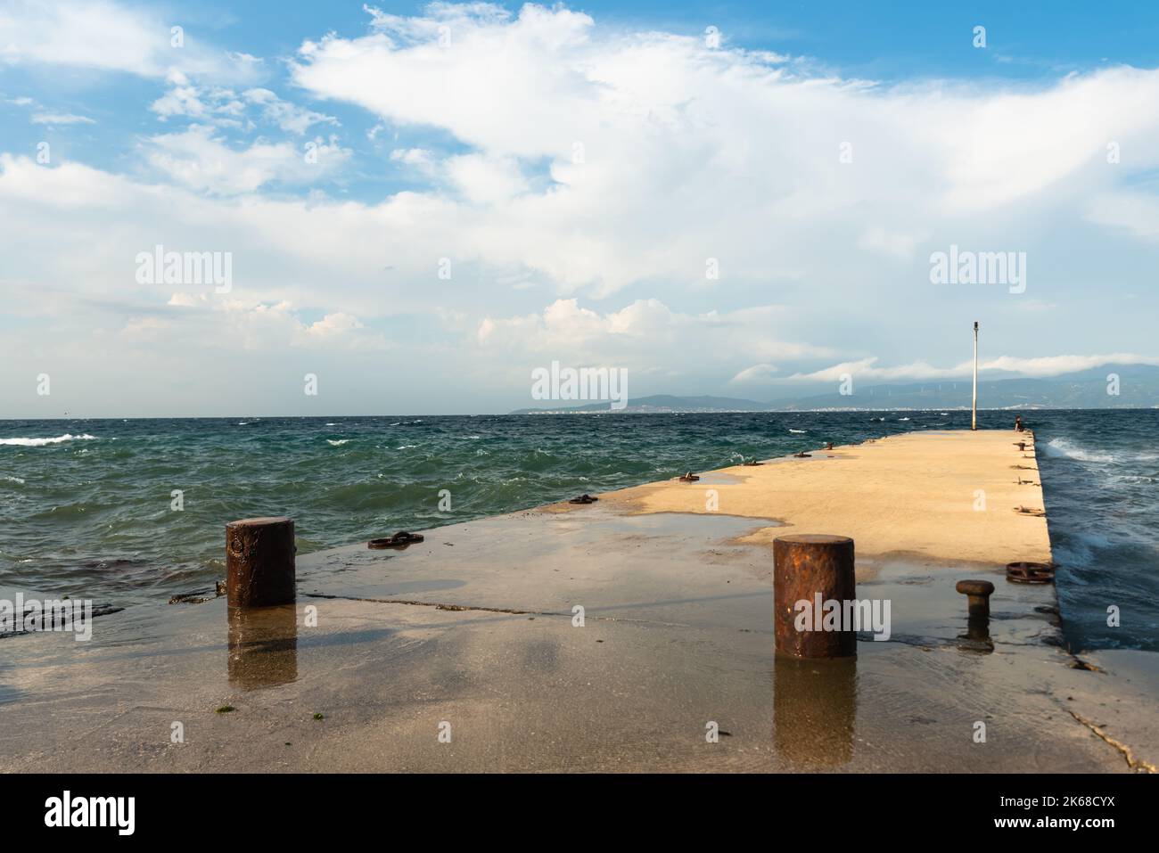 Sea waves break on a concrete pier.nautical concept background Stock ...