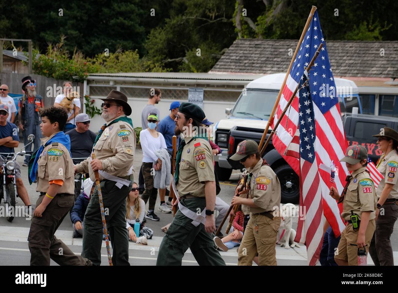 A band of boy scouts in uniforms marching in an independence day parade ...