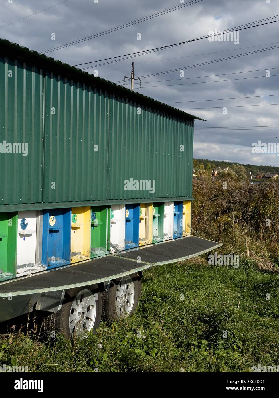 Multi-colored bee hives on a trailer. Mobile apiary Stock Photo - Alamy
