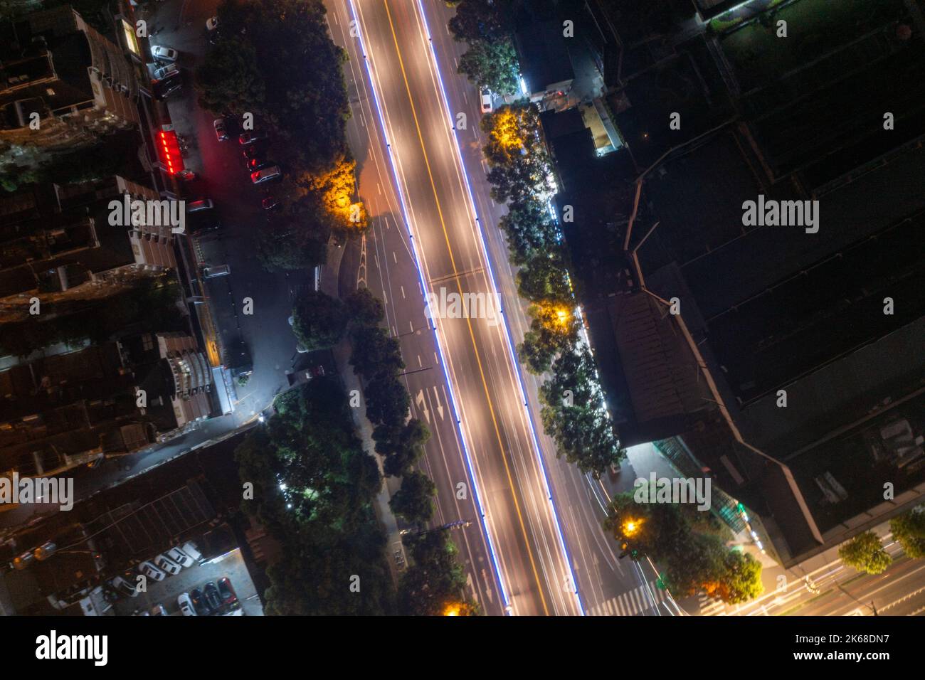 An aerial view of a street with illuminated lights at night in Hangzhou ...
