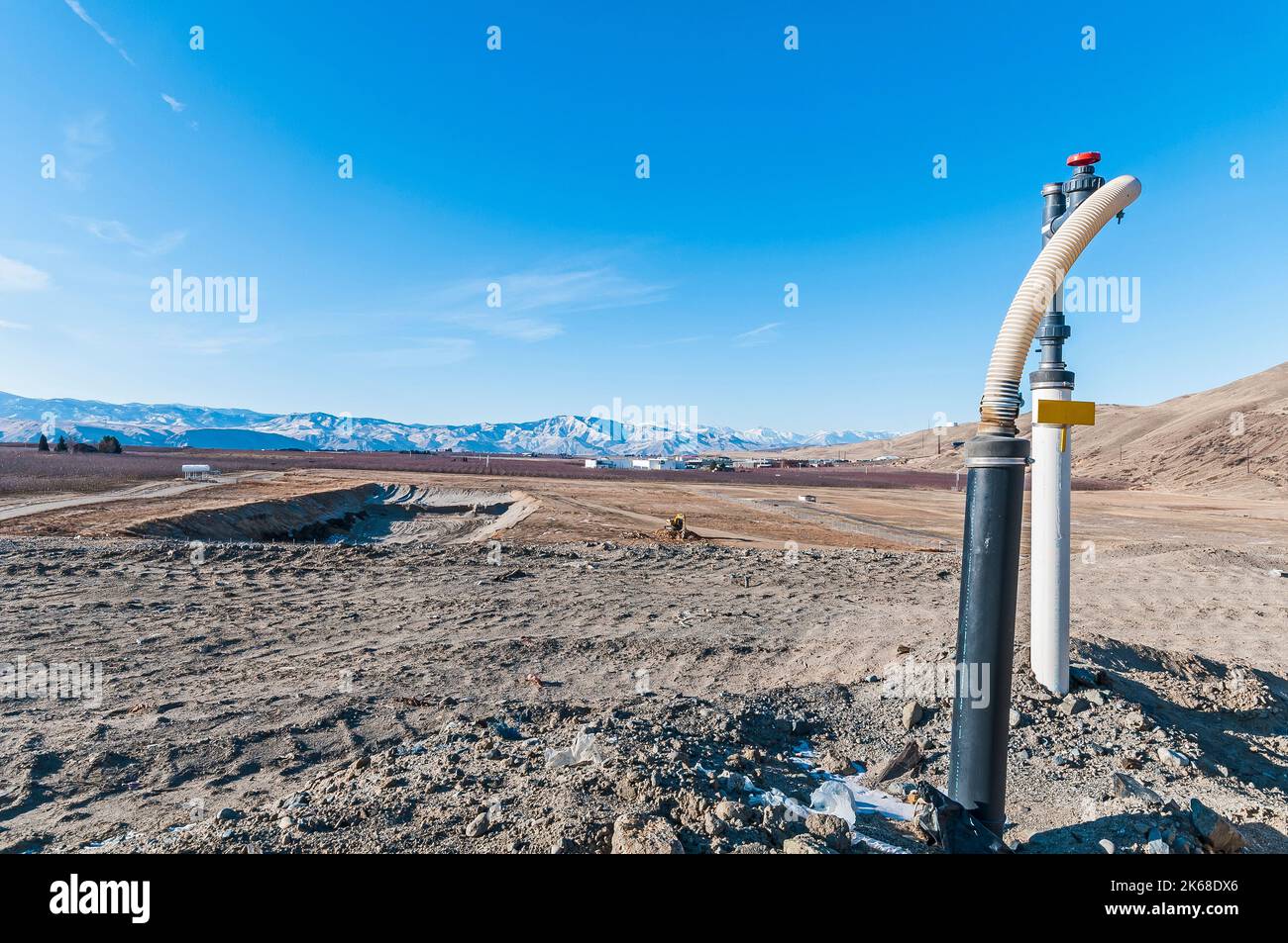 A vertical landfill methane gas well at an active landfill showing the ...