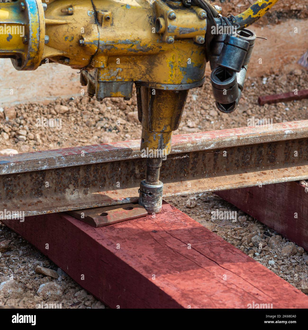 Railway workers bolting track rail. Detail worker with mechanical ...