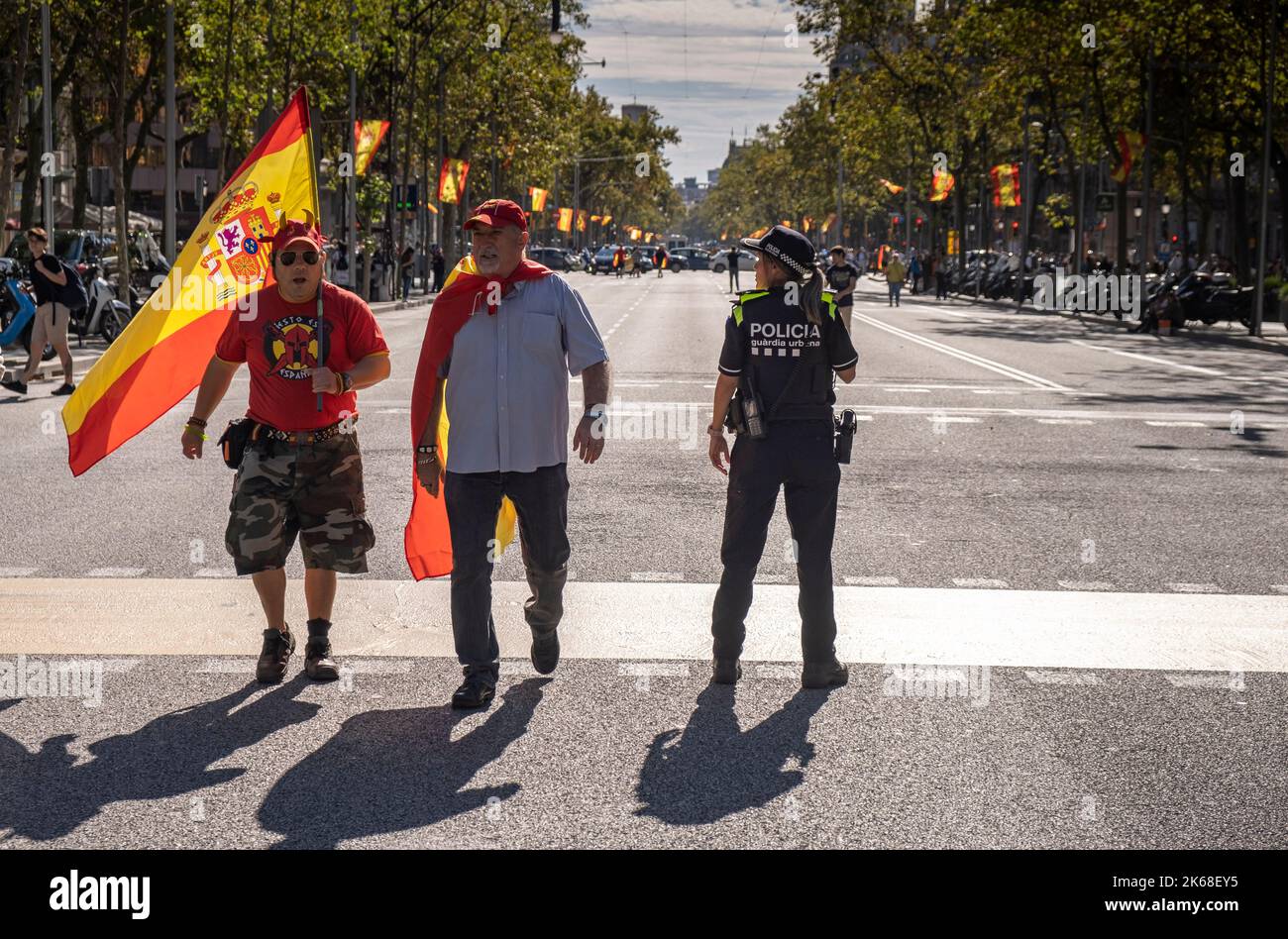Barcelona, Spain. 12th Oct, 2022. Two protesters carrying Spanish flags ...
