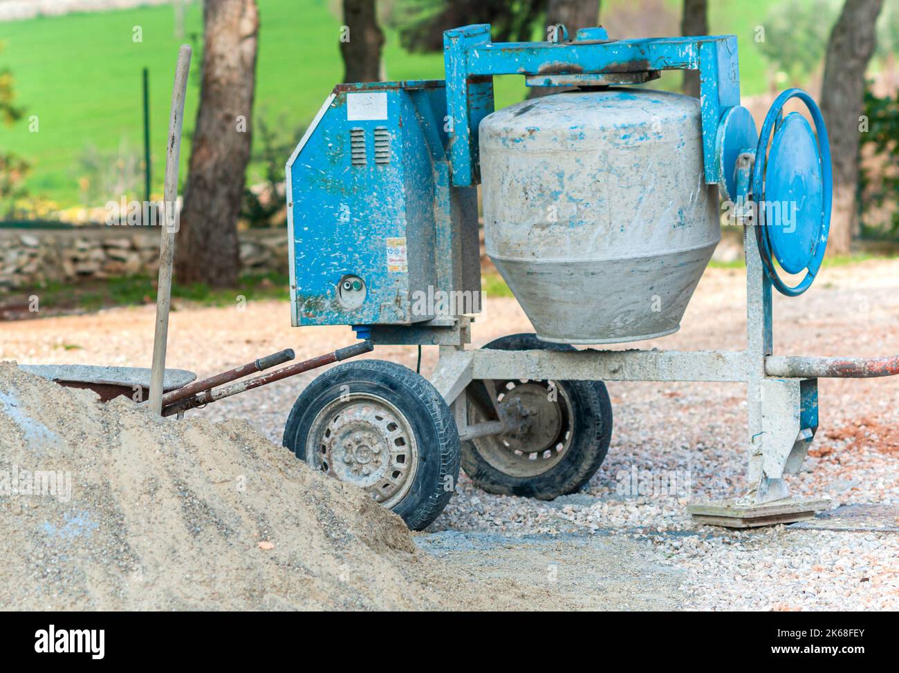 Cement mixer machine at construction site, tools and sand Stock Photo ...