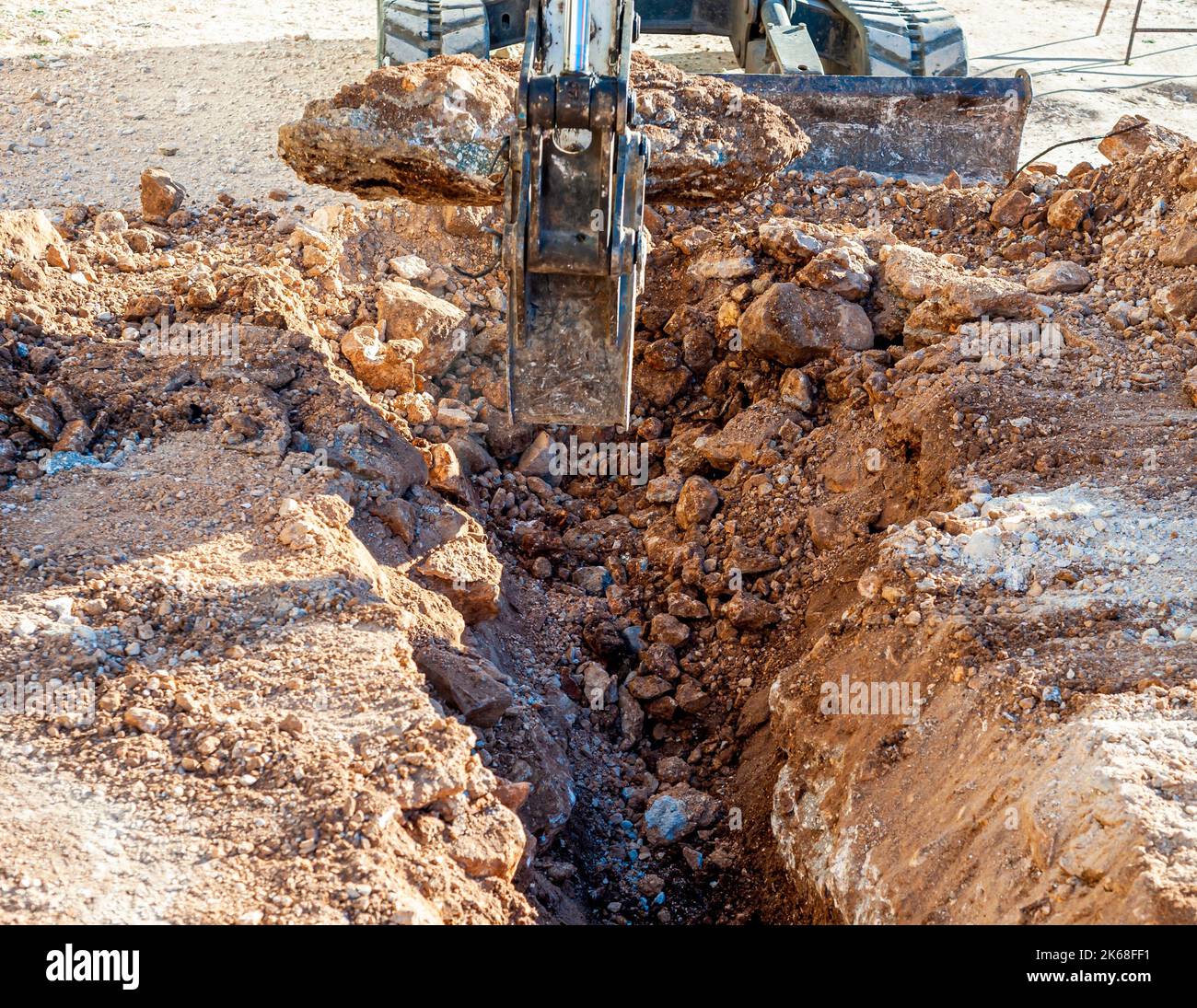 Excavator breaking and drilling the concrete road for repairing close ...