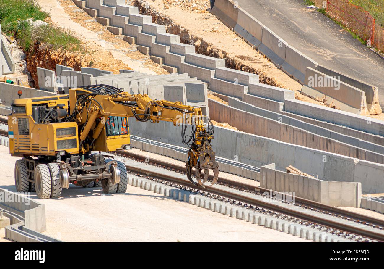 Backhoe and improvement construction of railway Stock Photo - Alamy