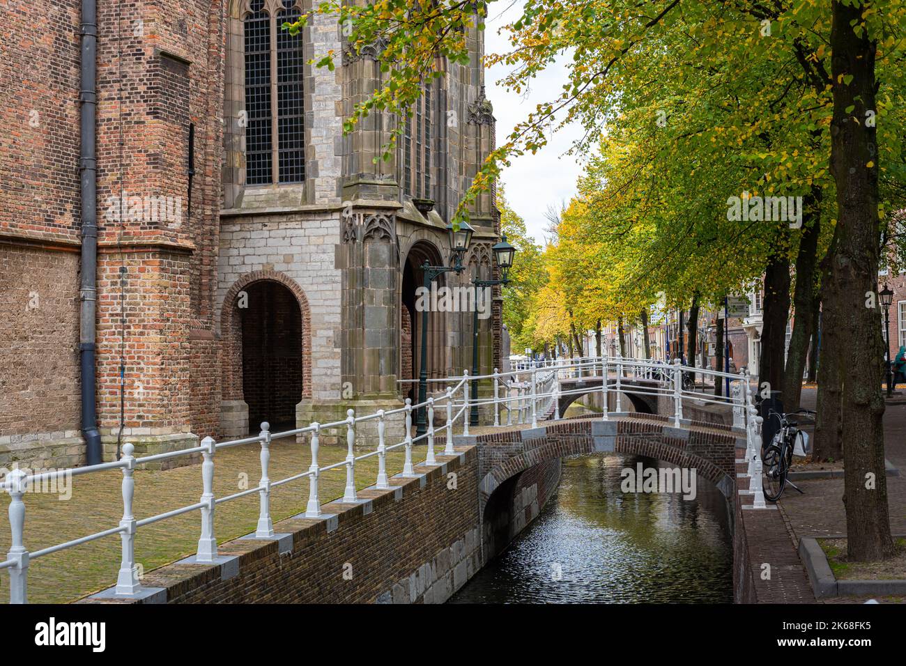Canal and bridge with trees in autumn leaf colors with on the left a ...