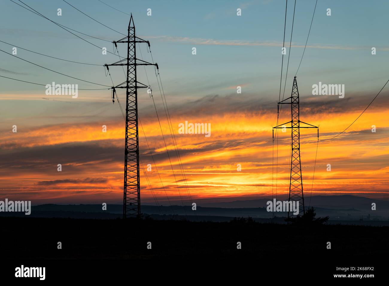Fiery sunrise in autumn in Czech Moravia and power lines Stock Photo ...