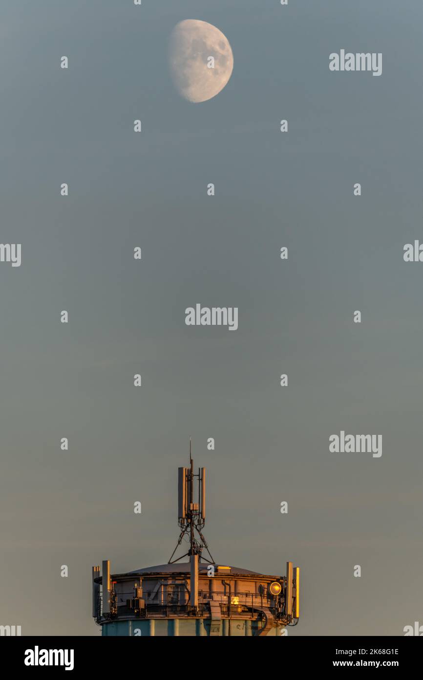 Moon over telecommunication antenna on water tower. France Stock Photo ...