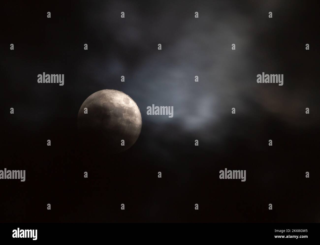 Ominous clouds pass in front of a full moon in the night sky Stock ...