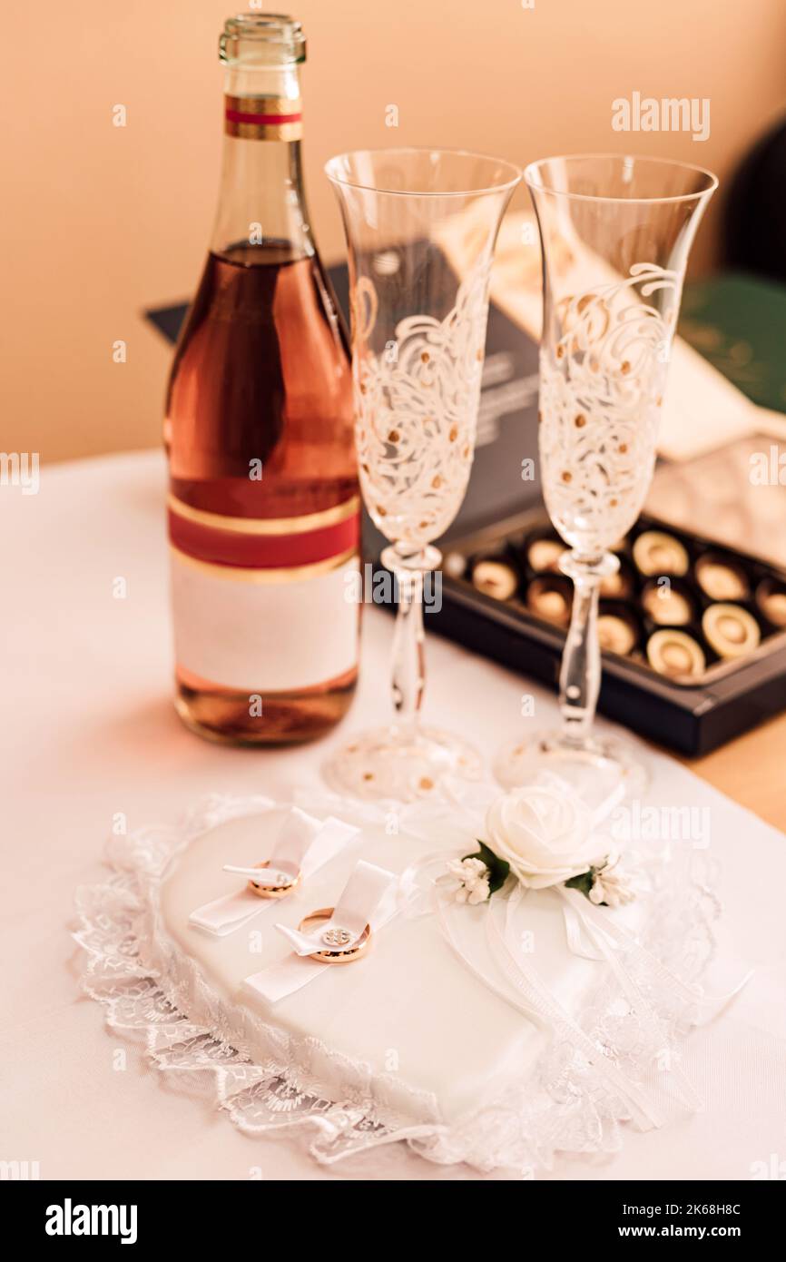 Wedding rings, champagne, sweets on the table. Wedding Day Stock Photo ...