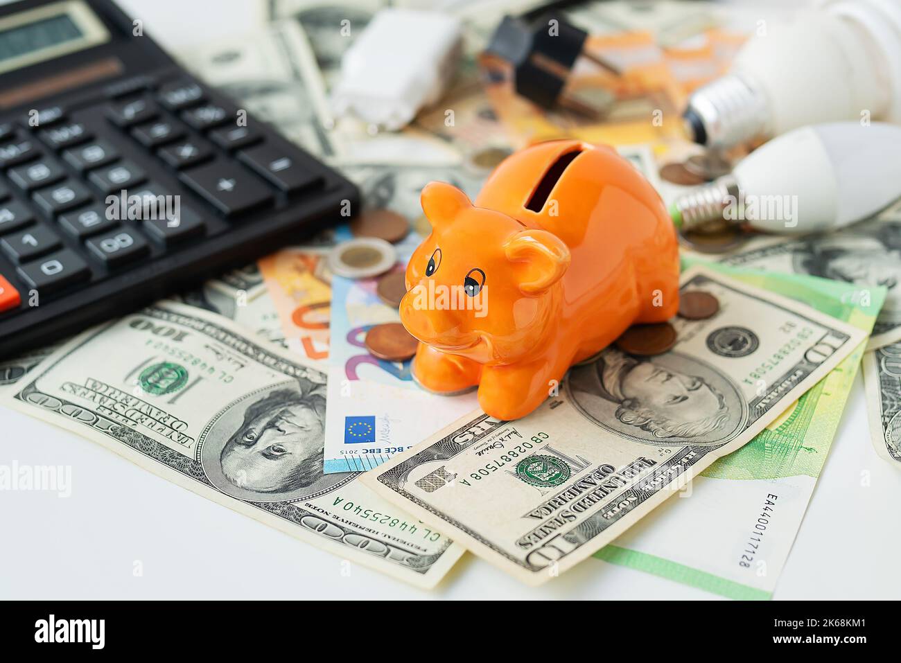 Piggy piggy bank of orange color soit on curry. Calculator, euro and ...