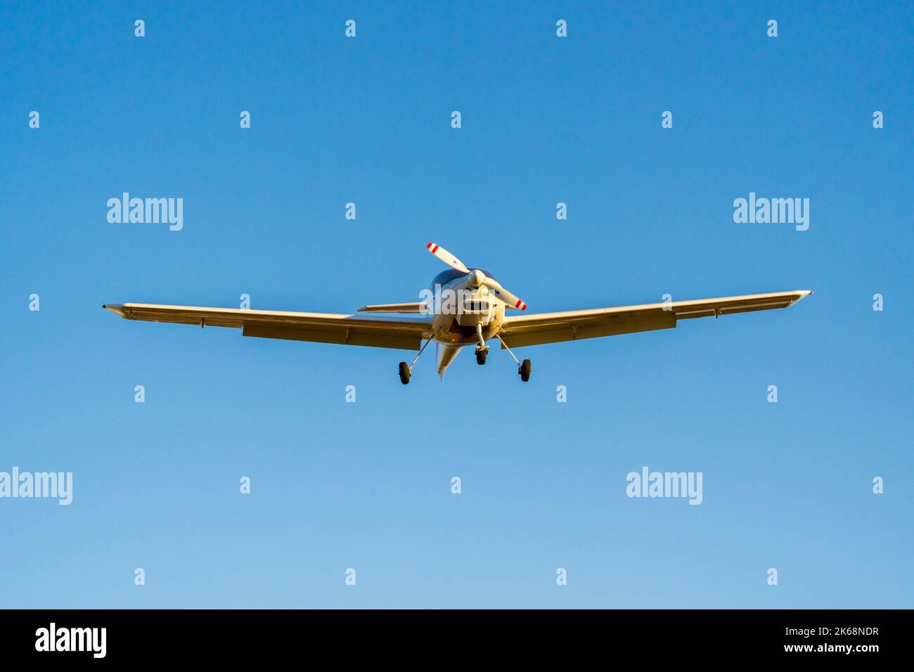 Single-propeller plane landing from a front view into a blue sky Stock ...