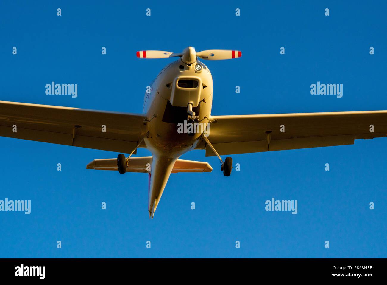 Single-propeller plane landing from a nose-down view centred in the ...