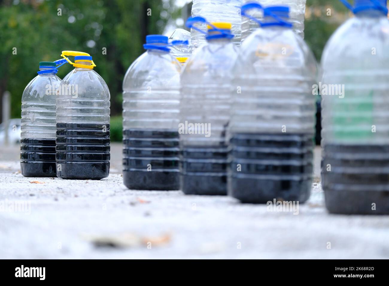 Big chess board of chalk with chess pieces made of plastic bottles seen ...