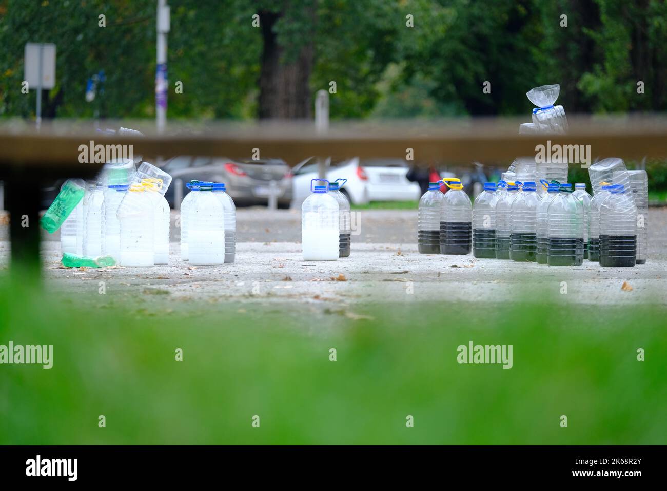 Big chess board of chalk with chess pieces made of plastic bottles seen ...