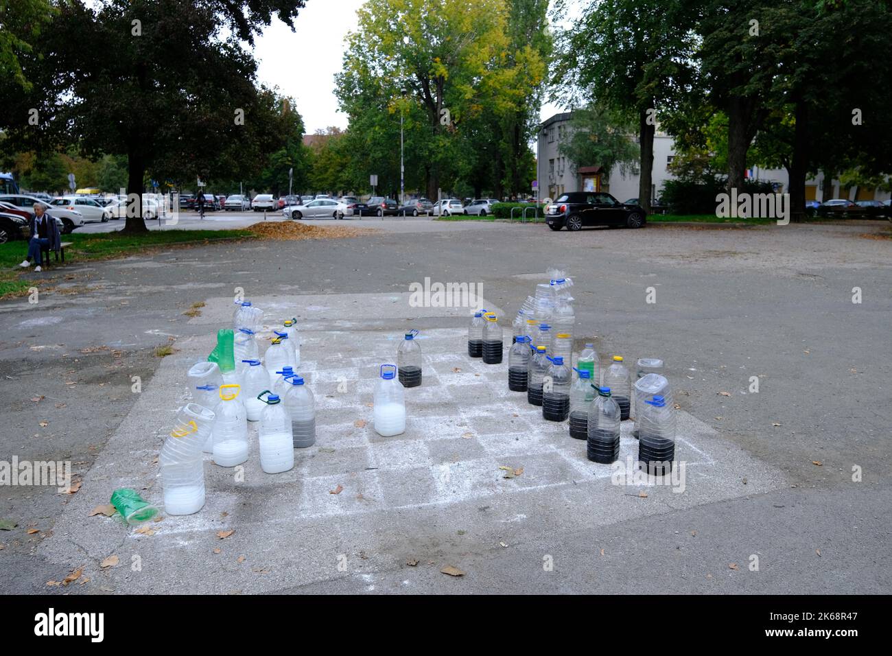 Big chess board of chalk with chess pieces made of plastic bottles seen ...
