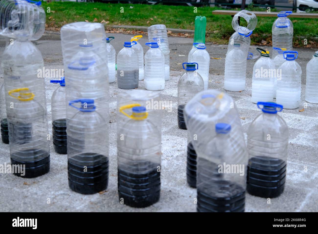 Big chess board of chalk with chess pieces made of plastic bottles seen ...