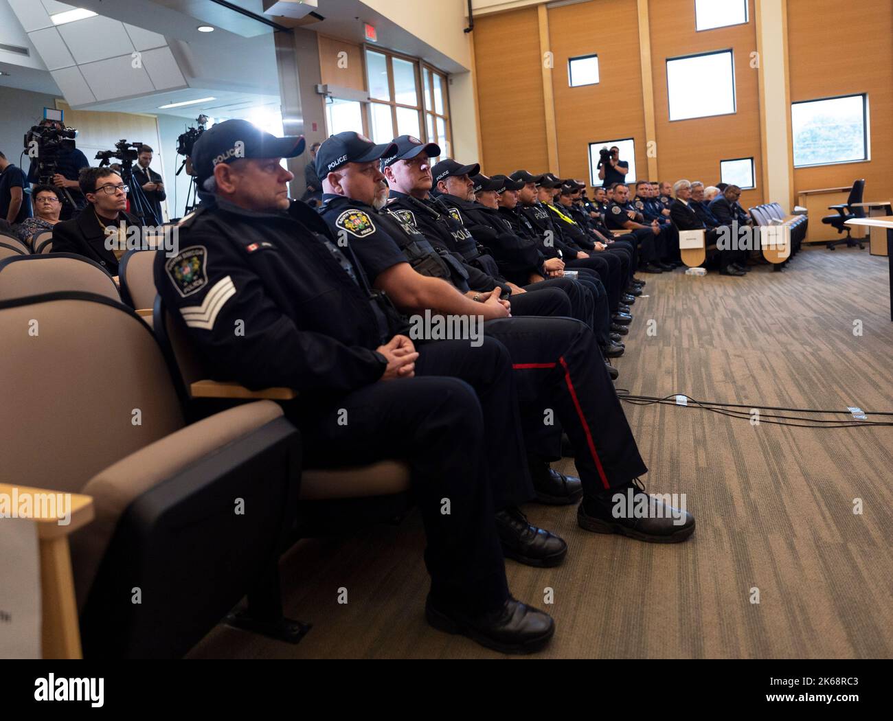 Police officers attend a press conference regarding two South Simcoe ...